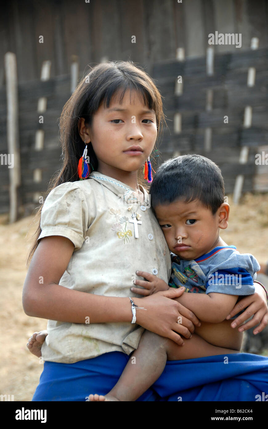 Big sister minding younger sibling, children of the Akha Meuo ethnic ...