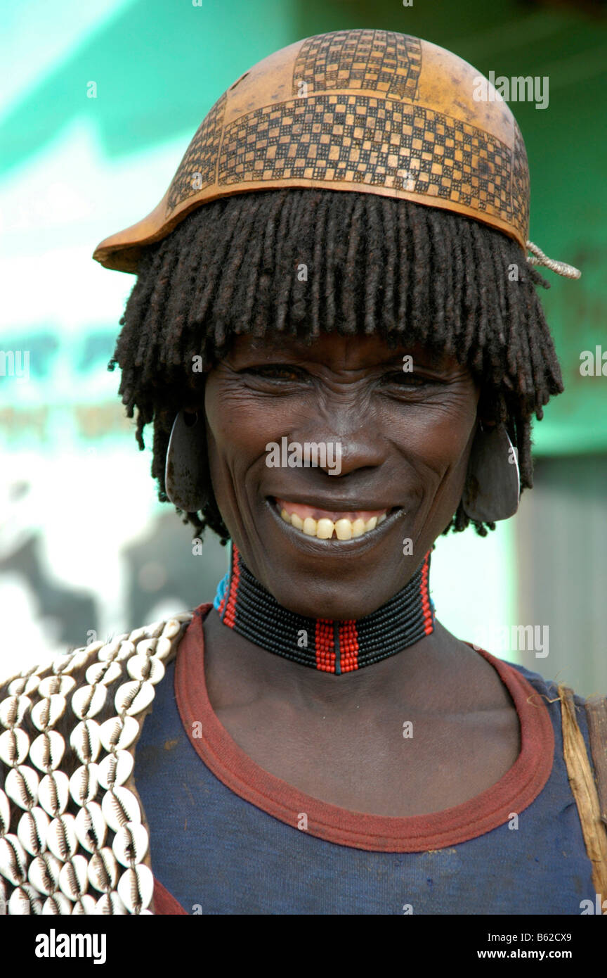 Portrait of a woman wearing a necklace made of cowry shells, calabash ...