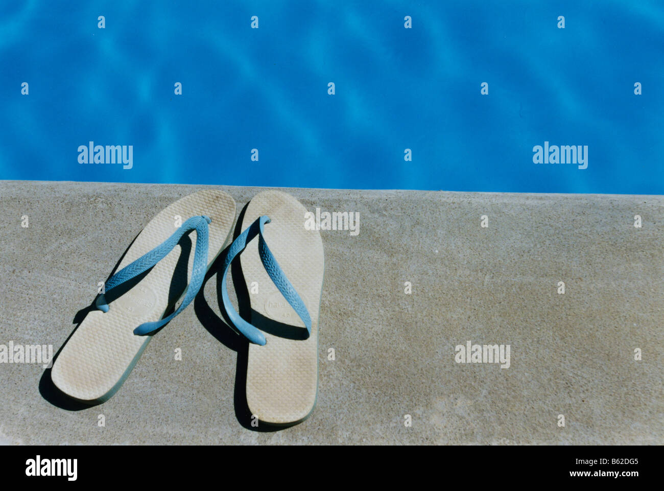 Swimming Pool, flip-flops next to Pool Stock Photo - Alamy