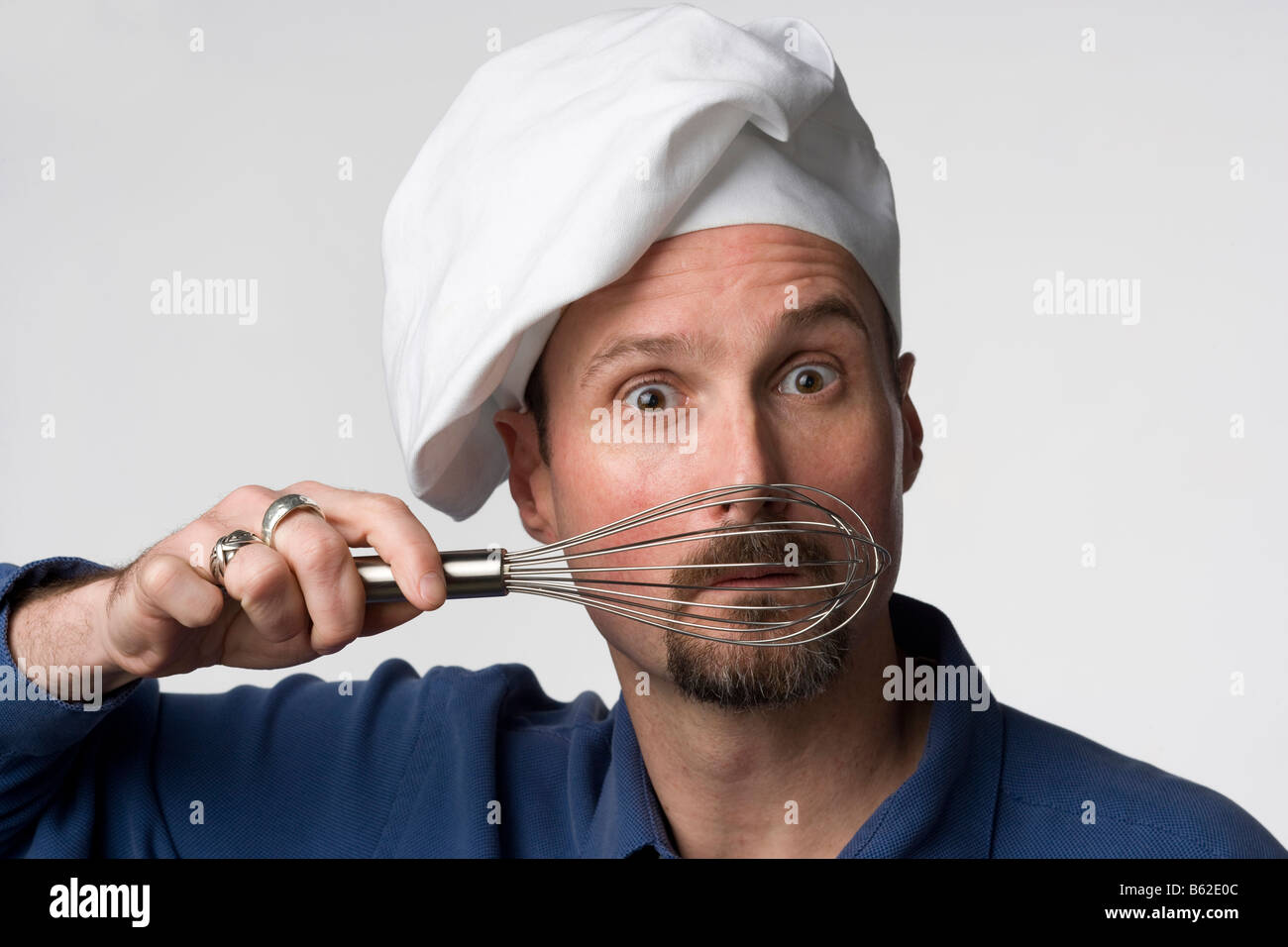 Portrait of a chef with a goatee holding a wisk Stock Photo - Alamy