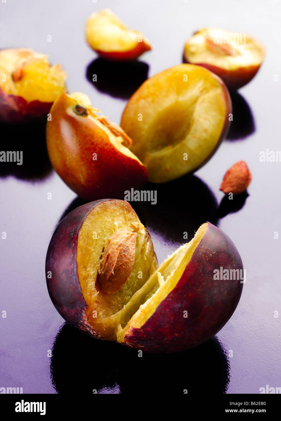 Detail fruit plum with seed on mirror background Stock Photo - Alamy