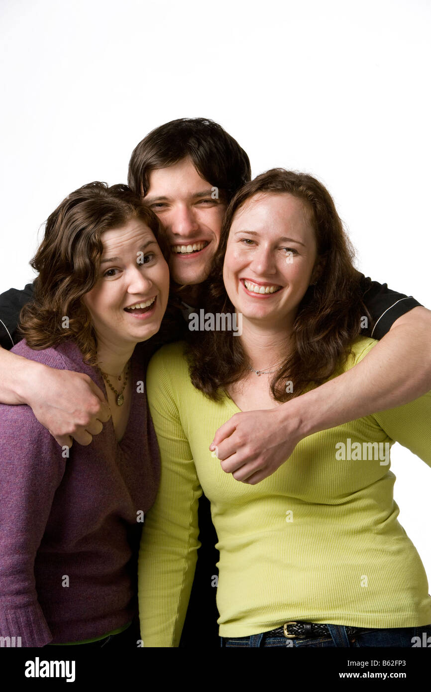 Portrait of three adult siblings on a white background Stock Photo - Alamy