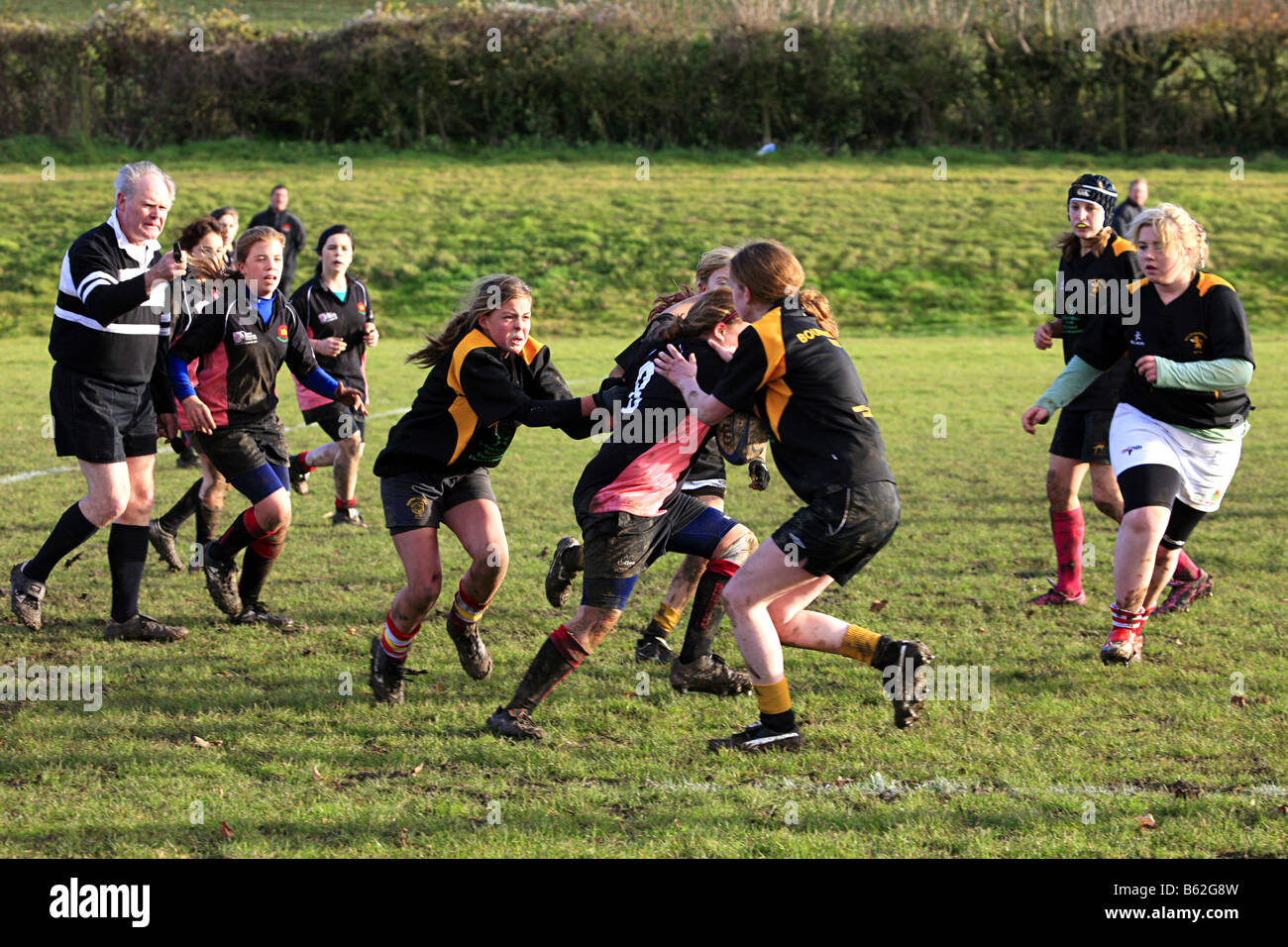 Teenage girls playing Rugby on a cold wet autumn afternoon Stock Photo ...