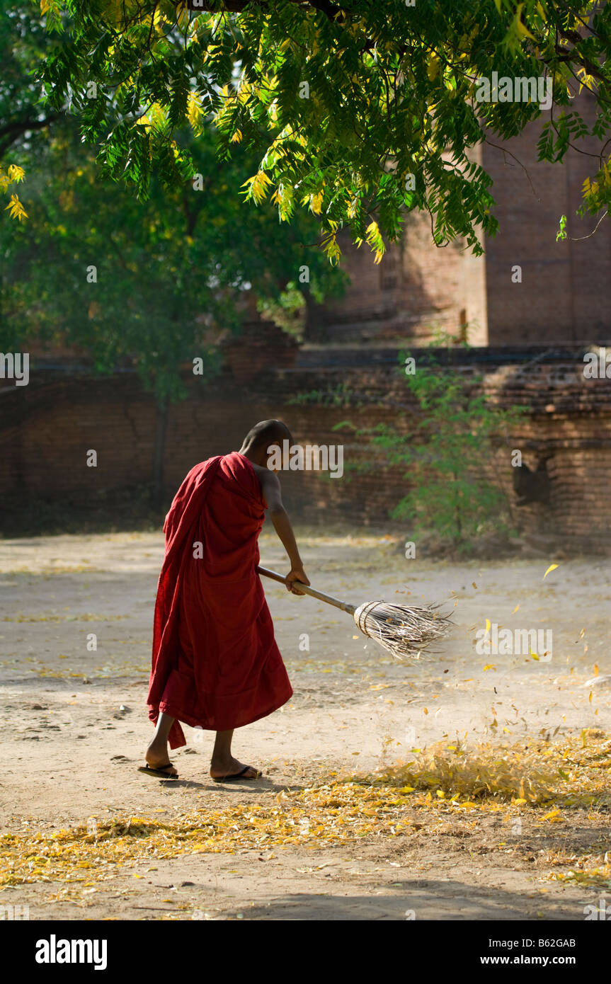 Buddhist monk sweeping leaves hi-res stock photography and images - Alamy