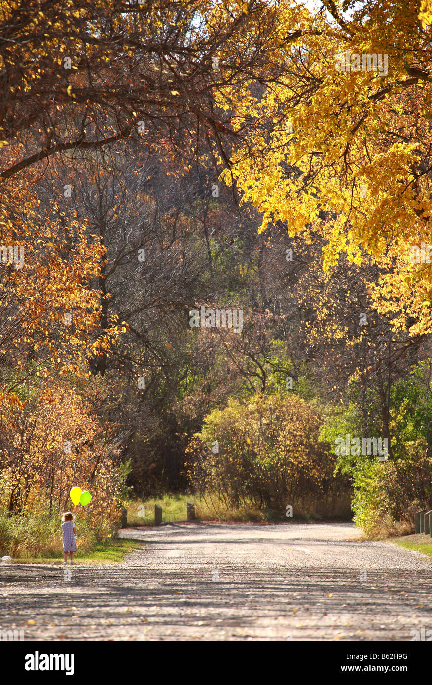 Boy with balloons in Wakamow Park during Moose Jaw fall Stock Photo - Alamy