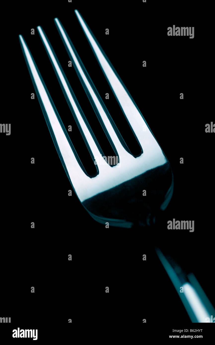 general everyday dining fork with blue toning applied Stock Photo - Alamy