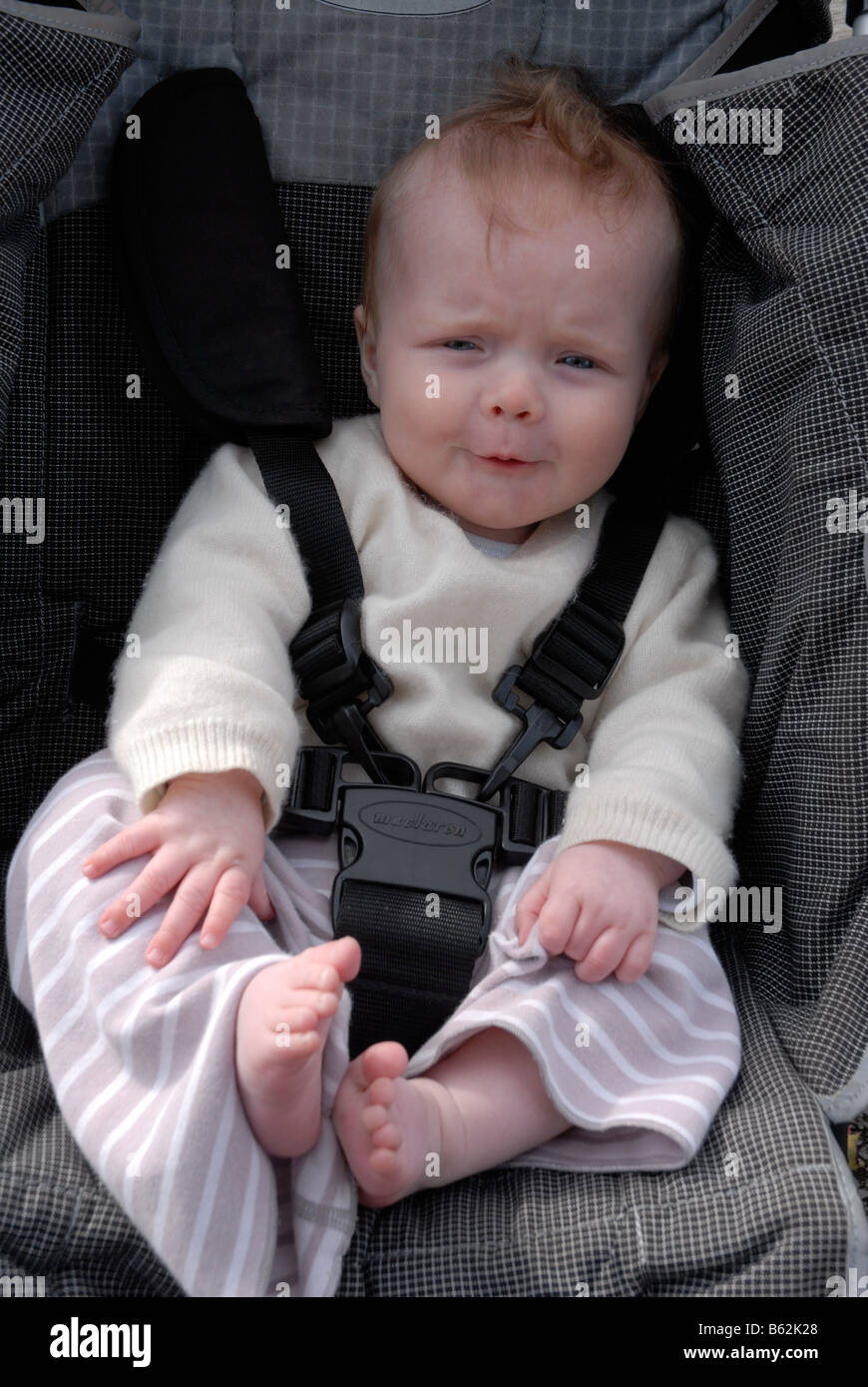 Baby boy strapped in a pushchair Stock Photo - Alamy