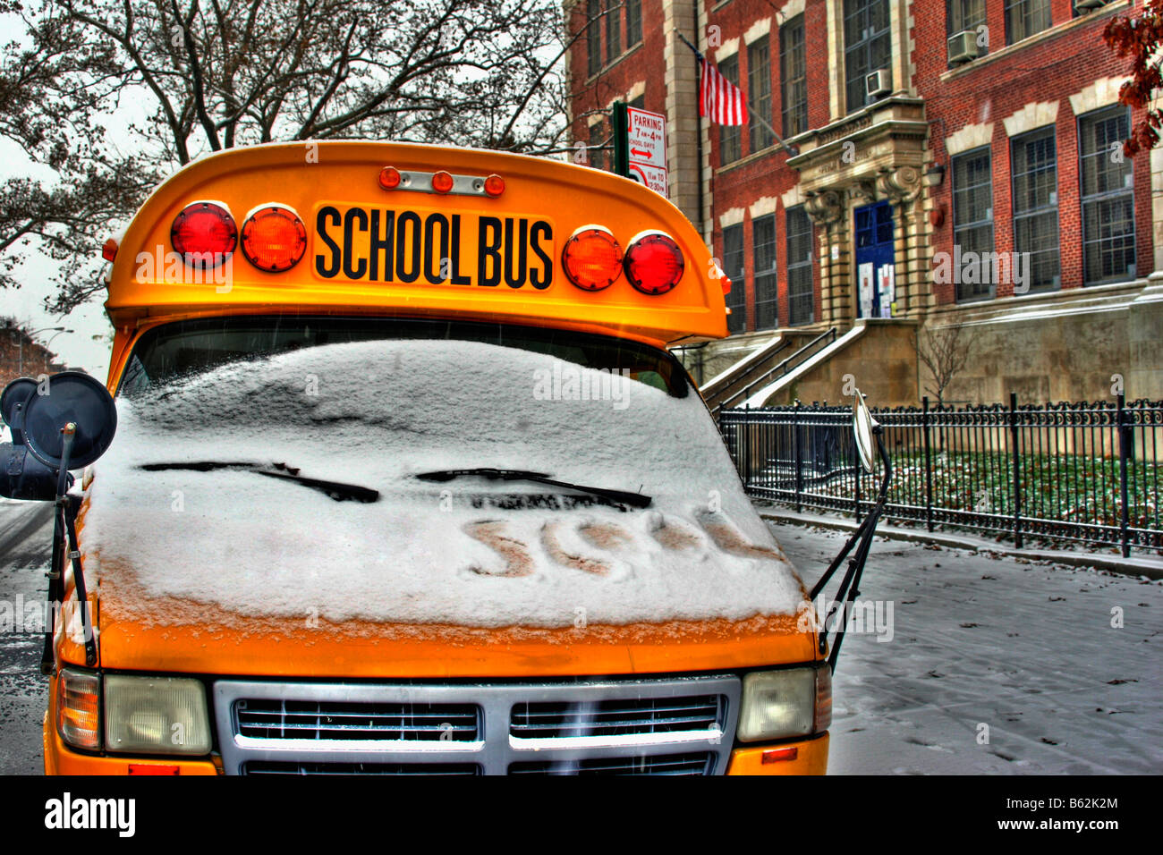 School bus parked near a building Stock Photo - Alamy