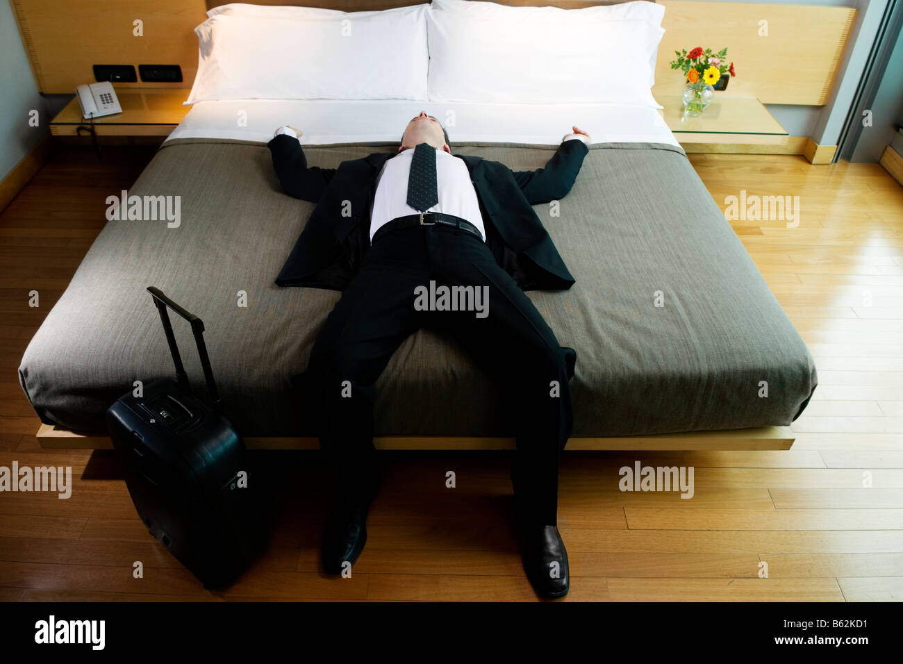 Businessman napping on the bed Stock Photo - Alamy
