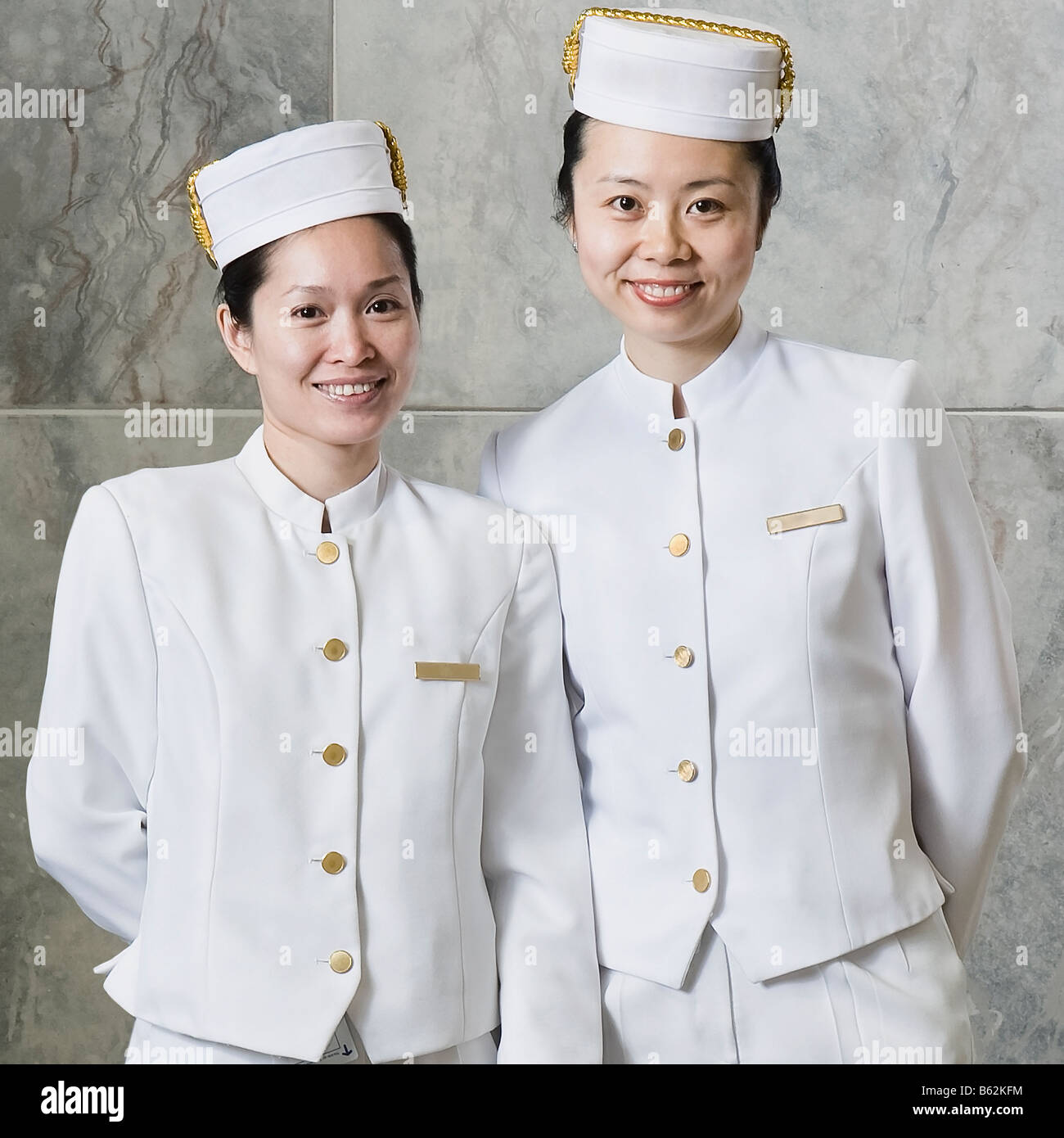 Portrait of two cabin crew smiling Stock Photo - Alamy