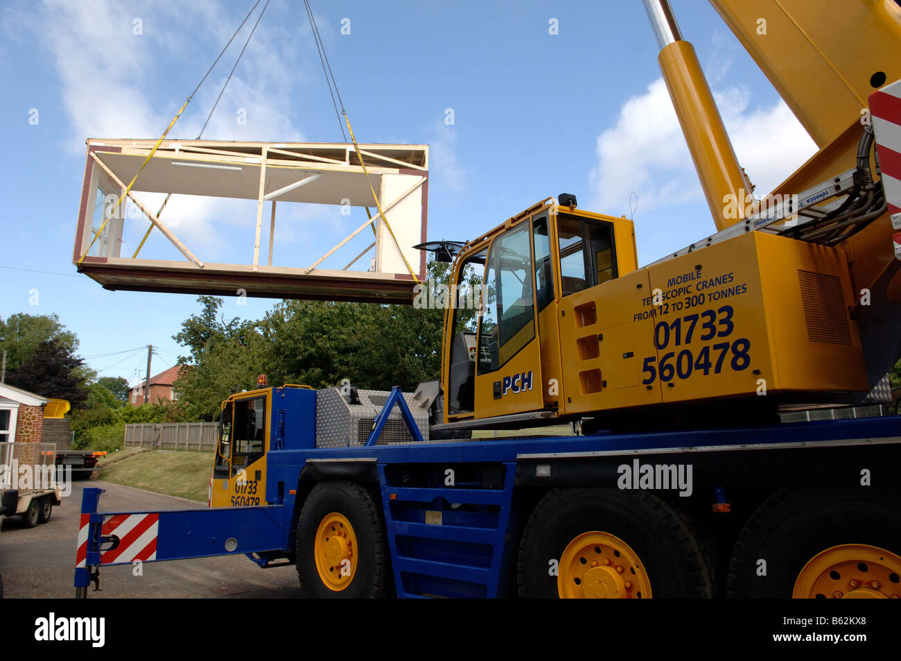 Crane lifting prefabricated building hi-res stock photography and ...