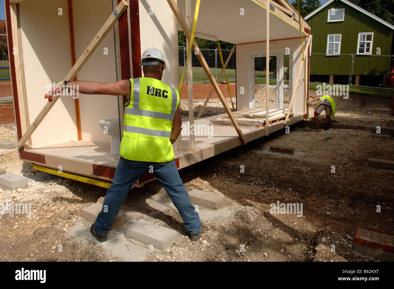lowering in modular building section in to place by crane Stock Photo ...