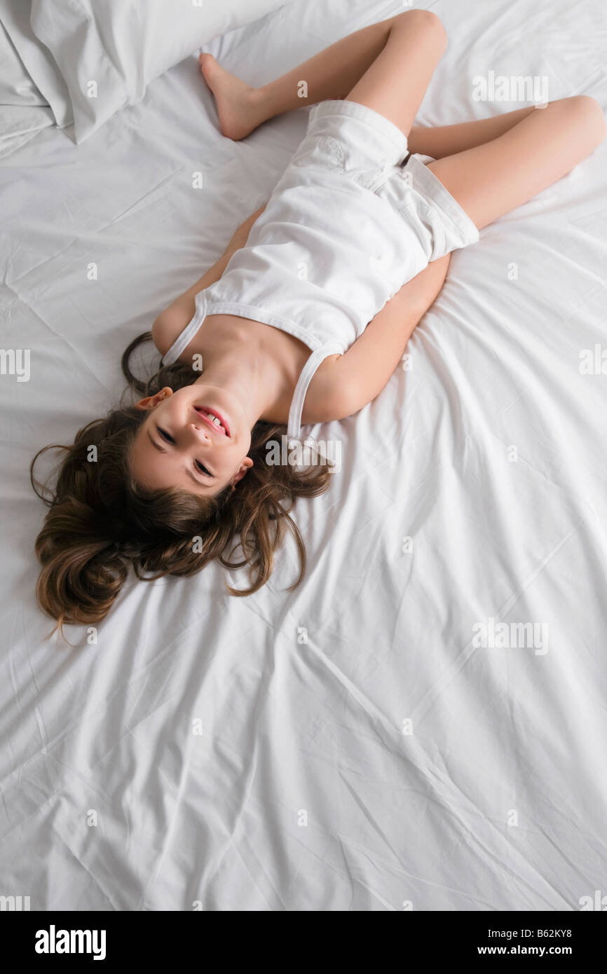 High angle view of a girl lying on the bed and smiling Stock Photo - Alamy