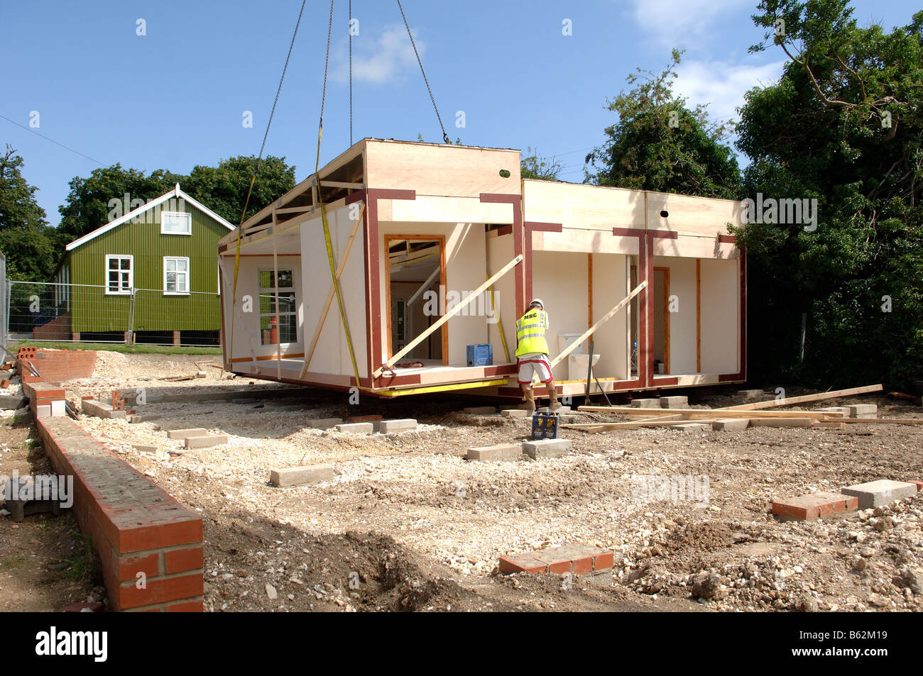 lowering in modular building section in to place by crane Stock Photo ...