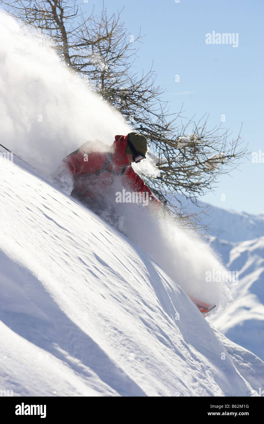Skier descending a steep slope hi-res stock photography and images - Alamy