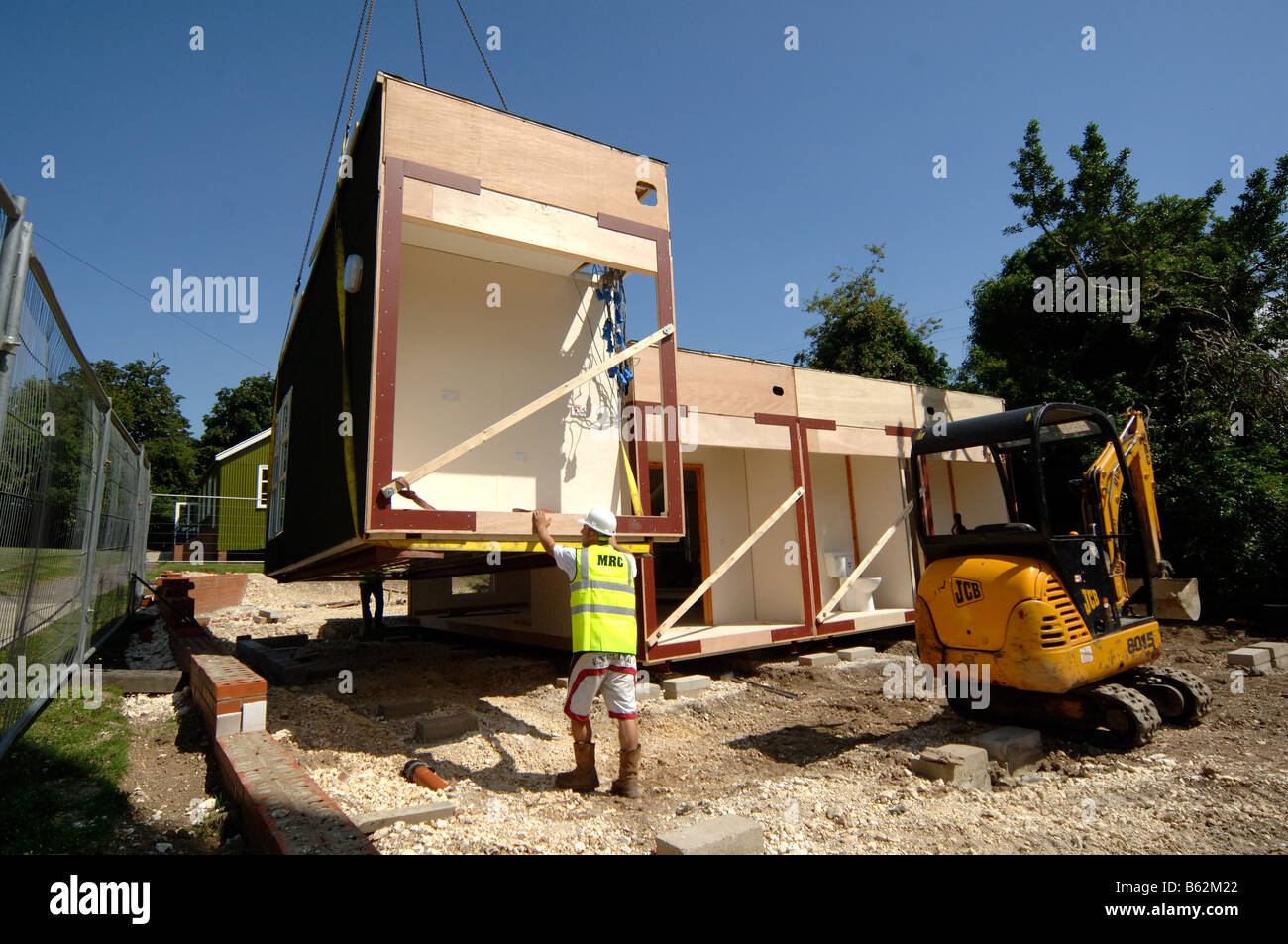 lowering in modular building section in to place by crane Stock Photo ...