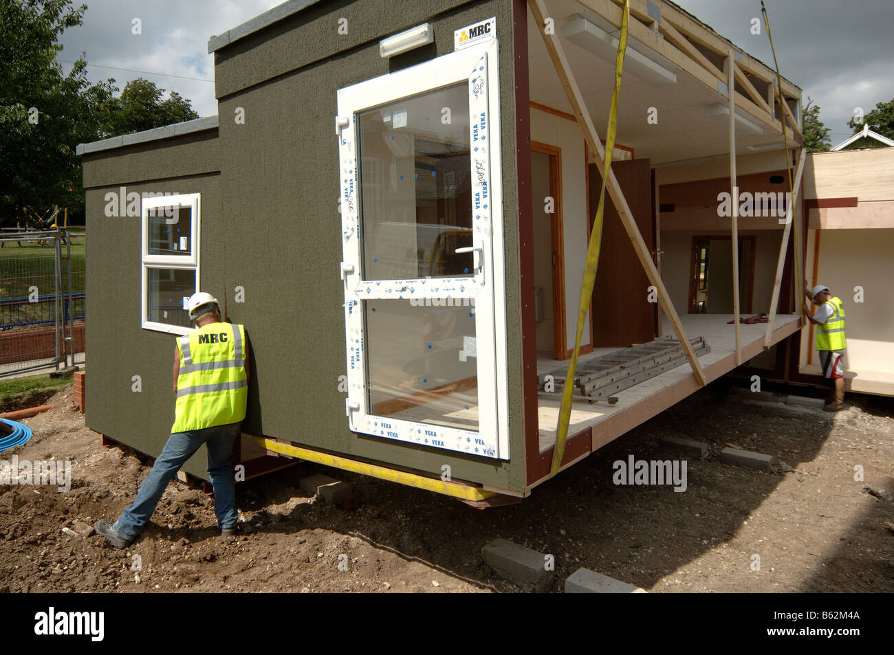 lowering in modular building section in to place by crane Stock Photo ...