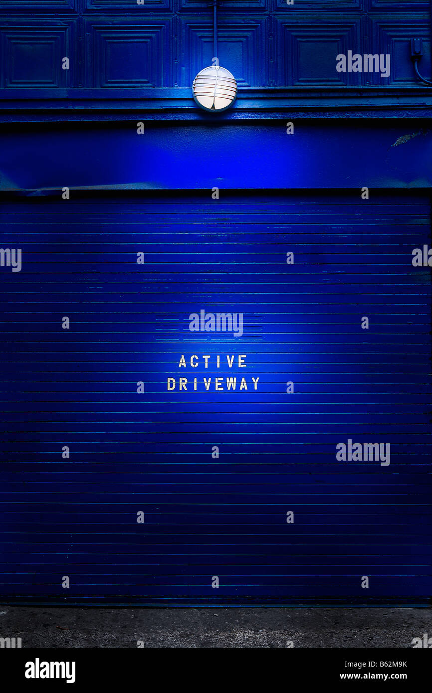 Active driveway sign on a blue painted wall Stock Photo - Alamy