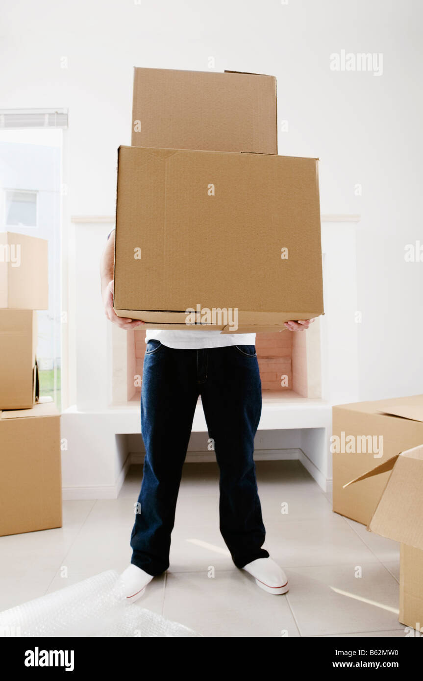Person carrying cardboard boxes Stock Photo - Alamy