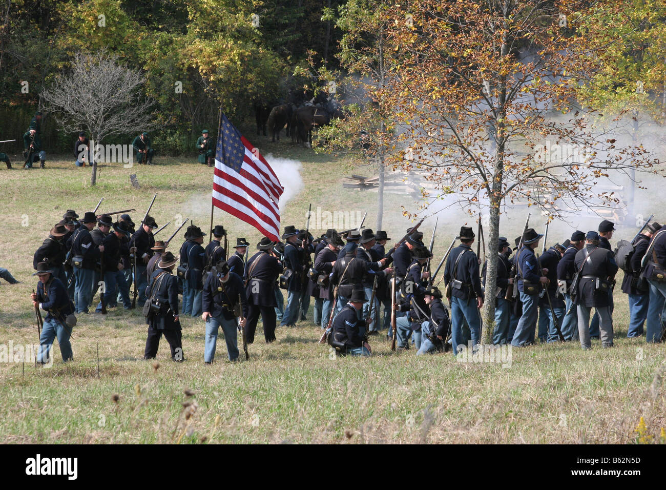 Confederate and Union soldiers stand off fighting a battle during a ...