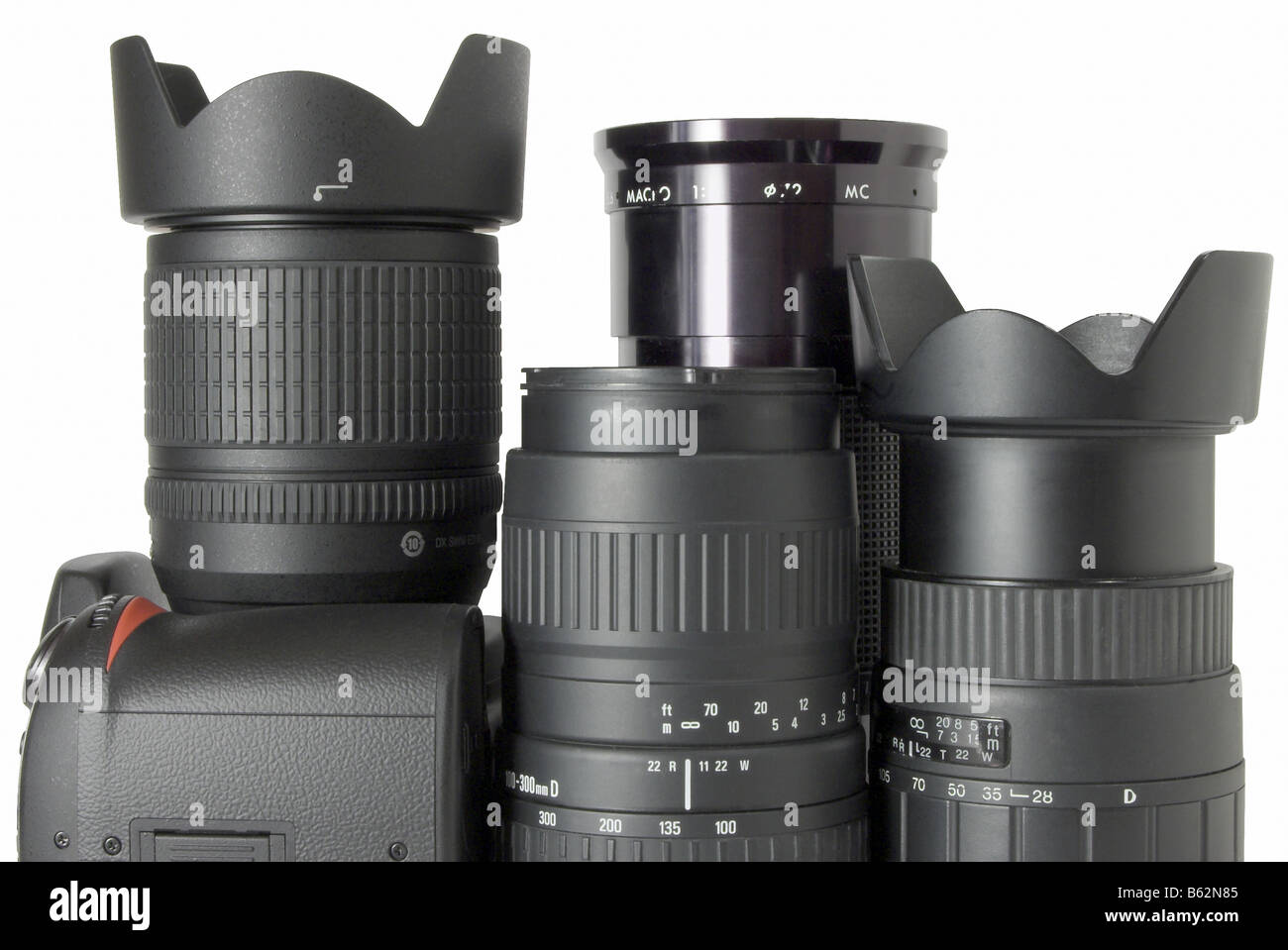 The digital camera and four lenses isolated over white with clipping ...