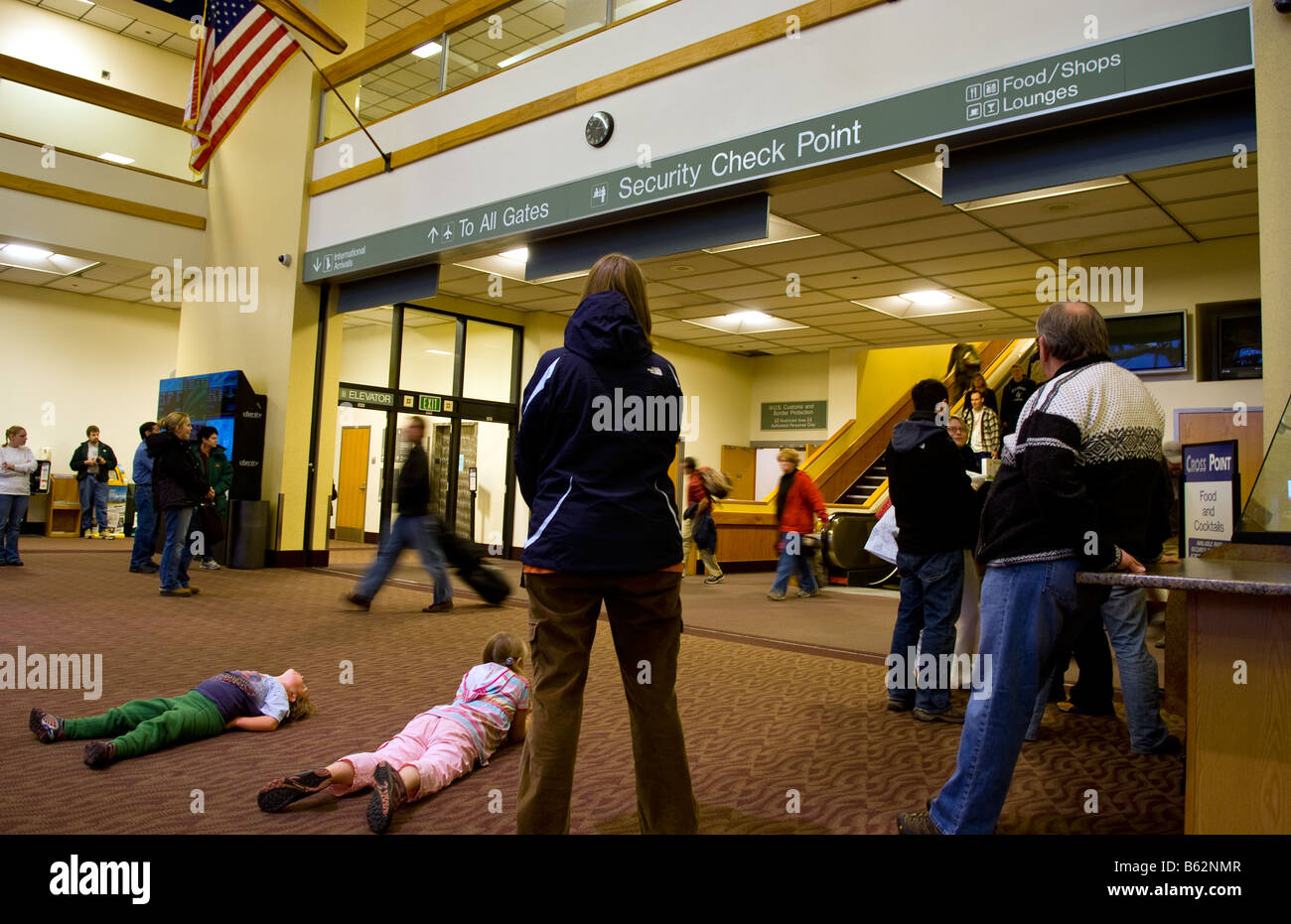 Family waiting for relative behind security gate while children look ...
