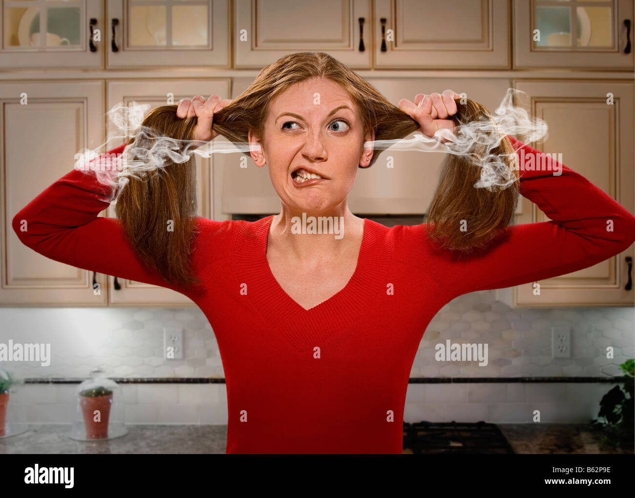 Young woman tearing her hair out Stock Photo - Alamy