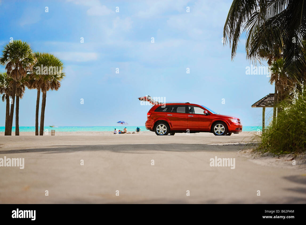 Red car on the beach Stock Photo - Alamy
