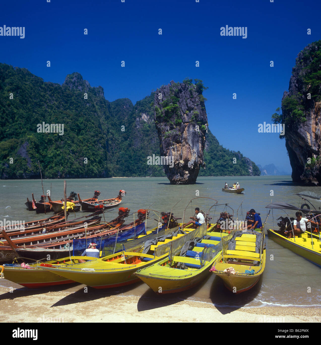 Tourist long tailed boats on beach near James Bond Island in Phang Nga ...