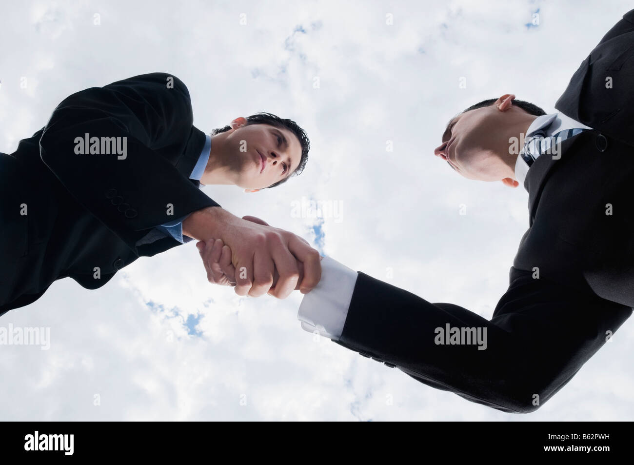 Low angle view of two businessmen shaking hands Stock Photo - Alamy