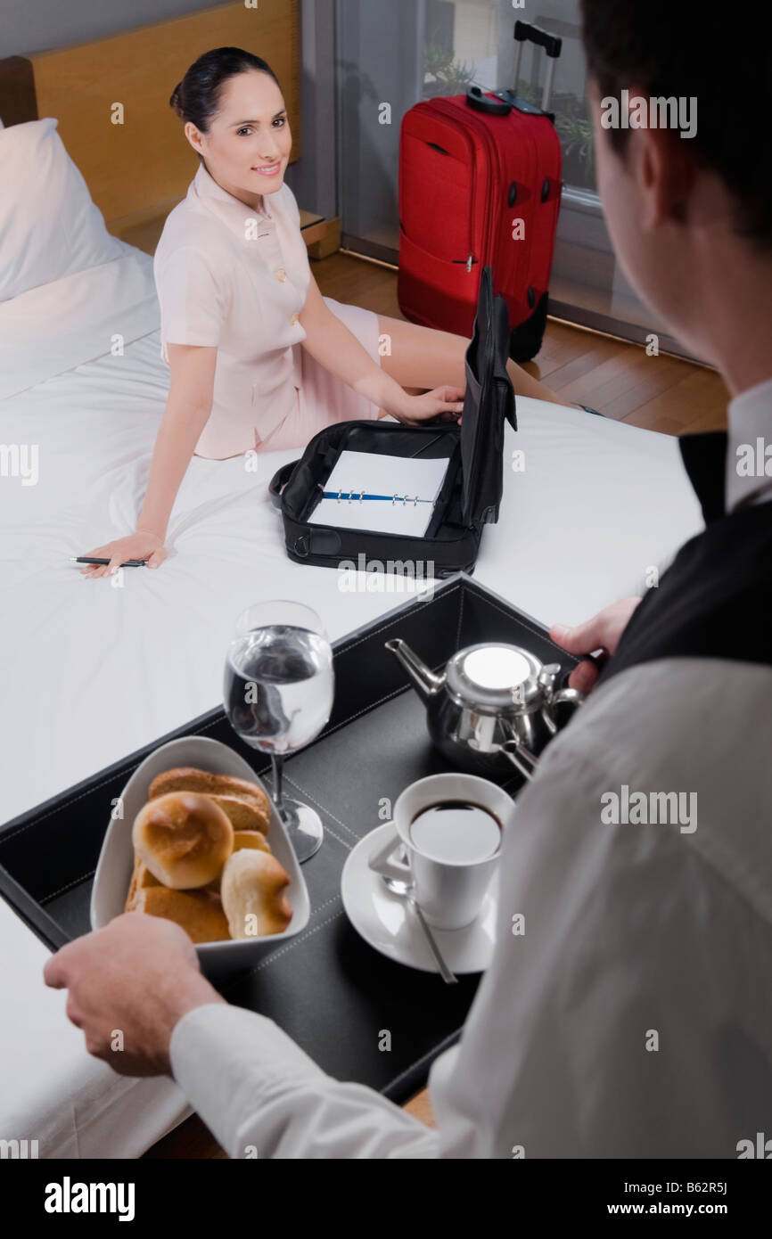 Waiter holding tray high hi-res stock photography and images - Alamy
