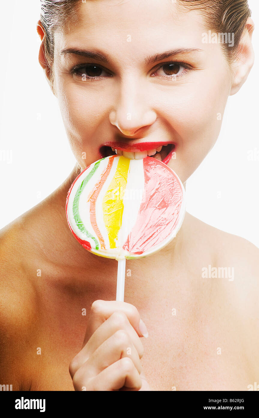 Portrait of a young woman eating a lollipop Stock Photo - Alamy