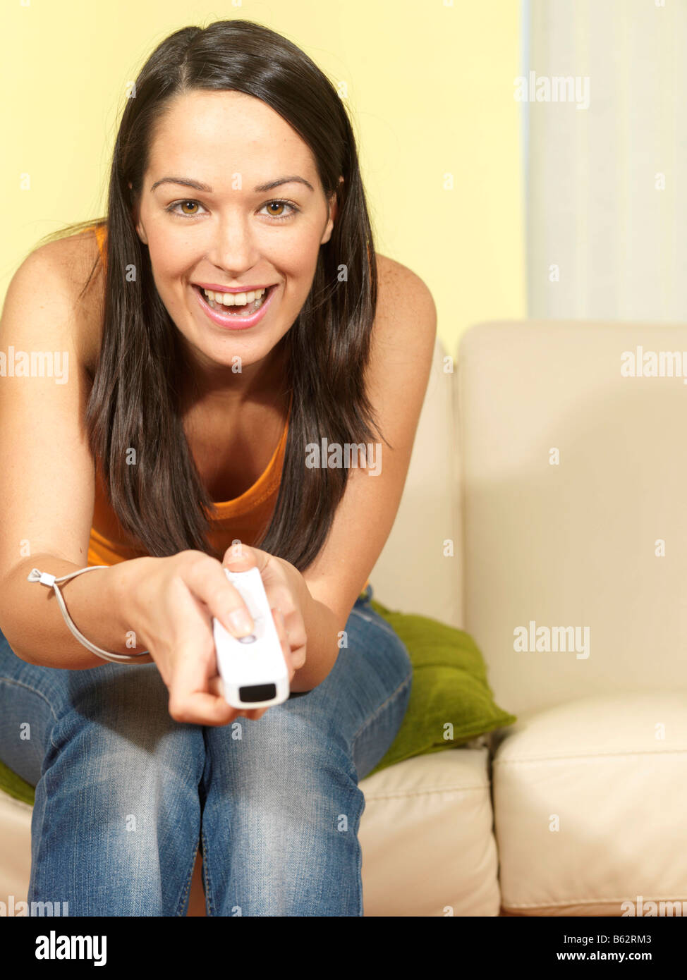 Young Woman Alone Playing Video Games Using A Remote Controller Having ...