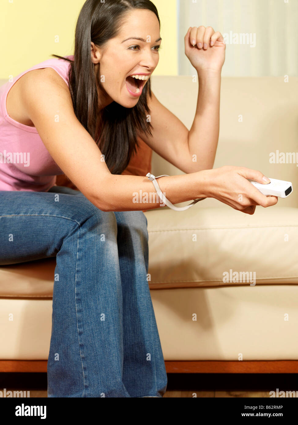 Young Woman Alone Playing Video Games Using A Remote Controller Having ...