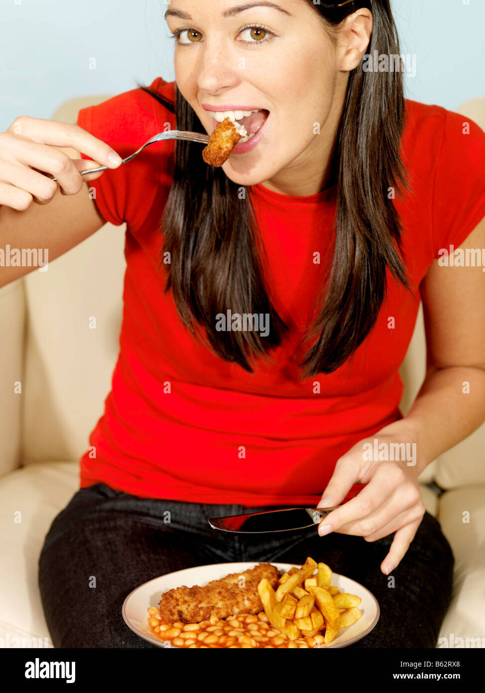 Young Woman Eating Fish Fingers Model Released Stock Photo - Alamy