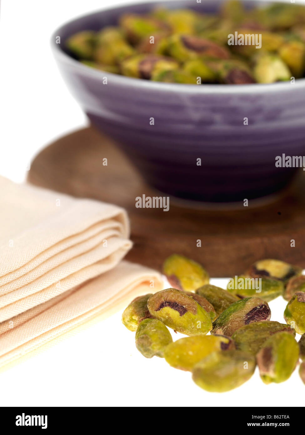 Fresh Shelled Green Pistachios Nuts In A Bowl Isolated Against A White ...