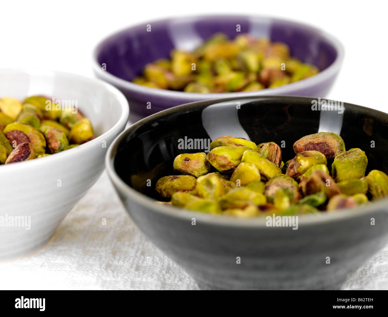 Fresh Shelled Green Pistachios Nuts In A Bowl Isolated Against A White ...