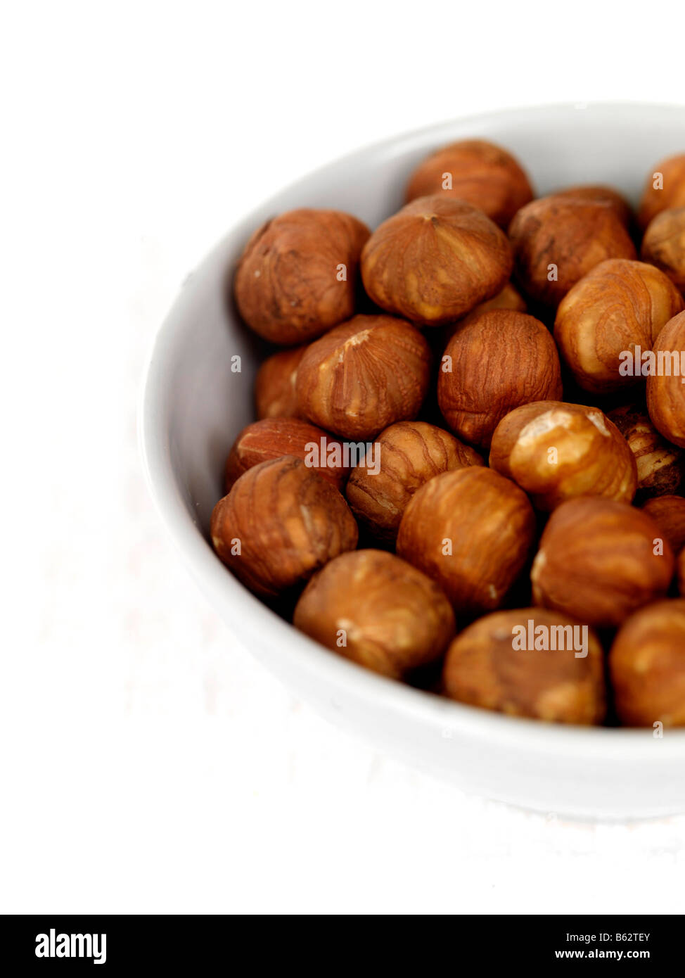 Bowl Of Fresh Healthy Hazelnuts Isolated Against A White Background ...