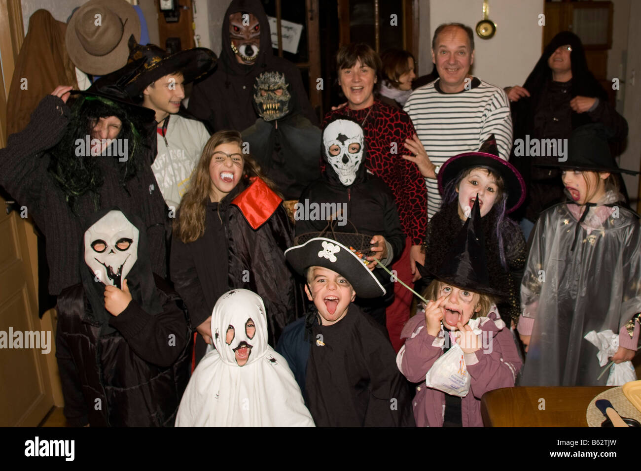 Young people trick and treat halloween party wearing masks black shirts ...