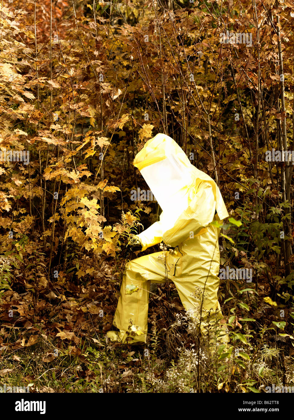 43 year old asian male in a hazmat suit and gas mask outdoors with the ...