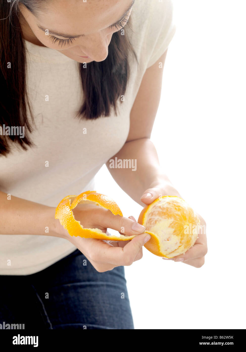 Young Woman Peeling An Orange Model Released Stock Photo - Alamy