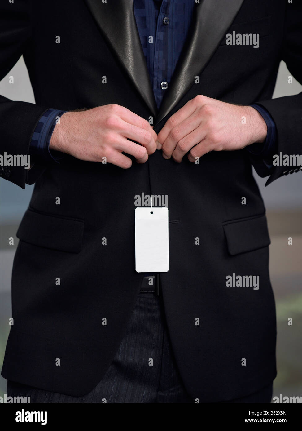 Mid section view of a man buttoning his coat Stock Photo - Alamy