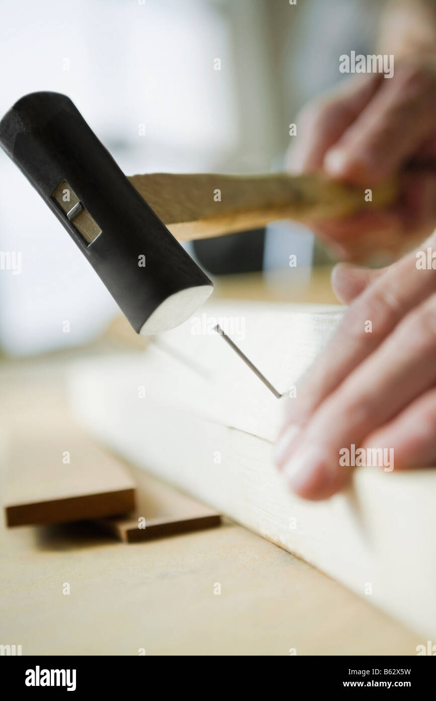 Hand holding hammer nail hi-res stock photography and images - Alamy