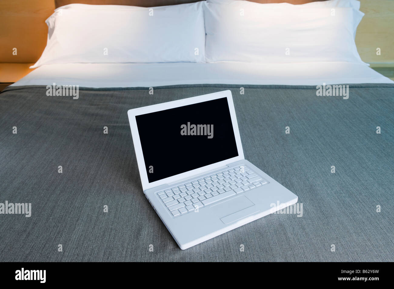 Laptop on the bed in a hotel room Stock Photo - Alamy