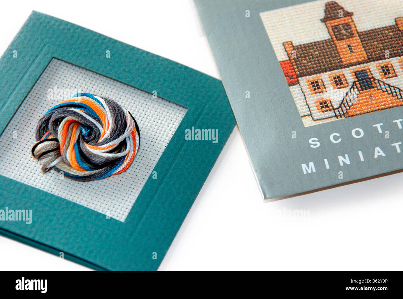 A miniature embroidery set with picture, frame, and threads Stock Photo ...