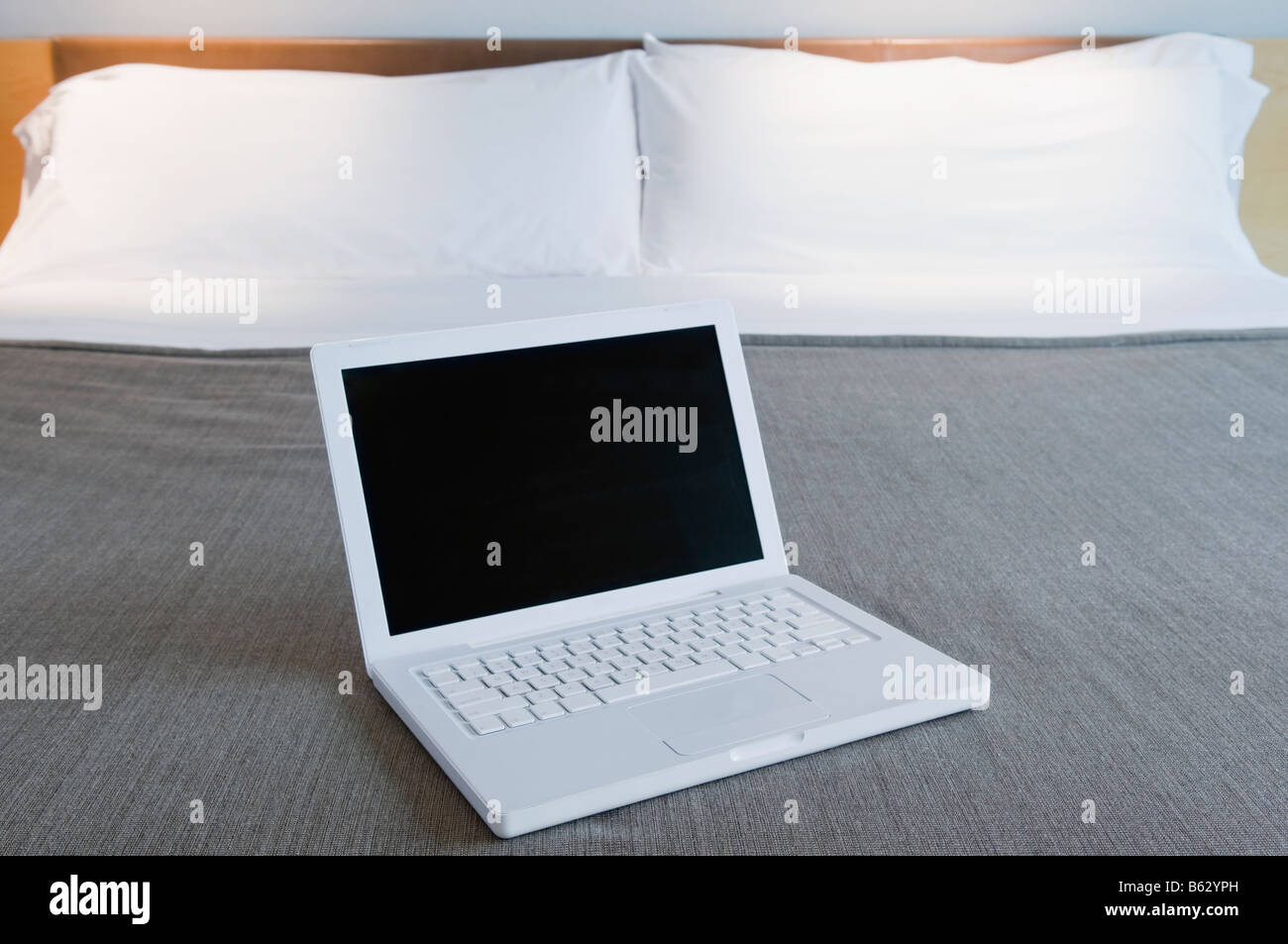 Laptop on the bed in a hotel room Stock Photo - Alamy