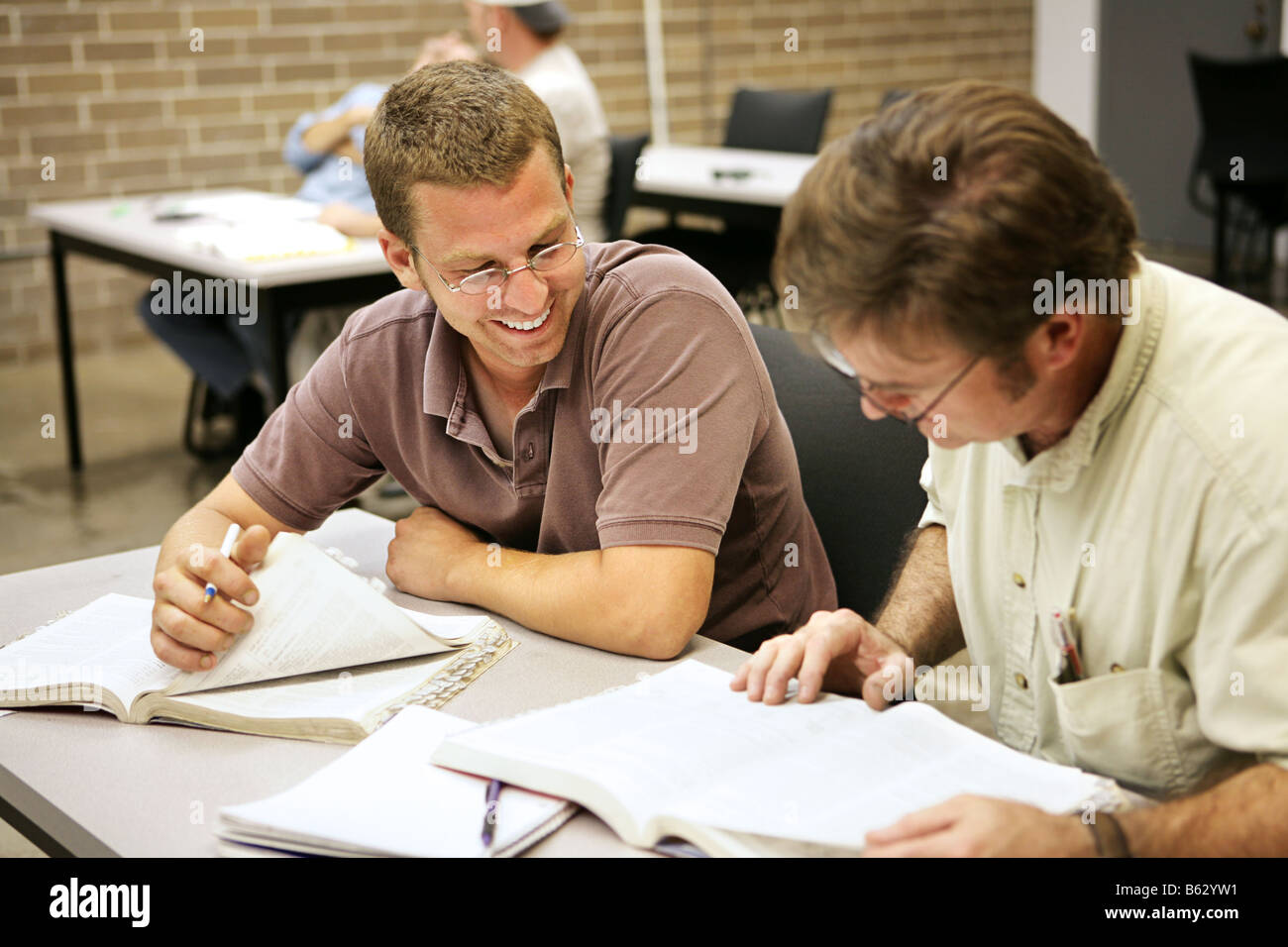 Adult education students studying together in class Stock Photo - Alamy
