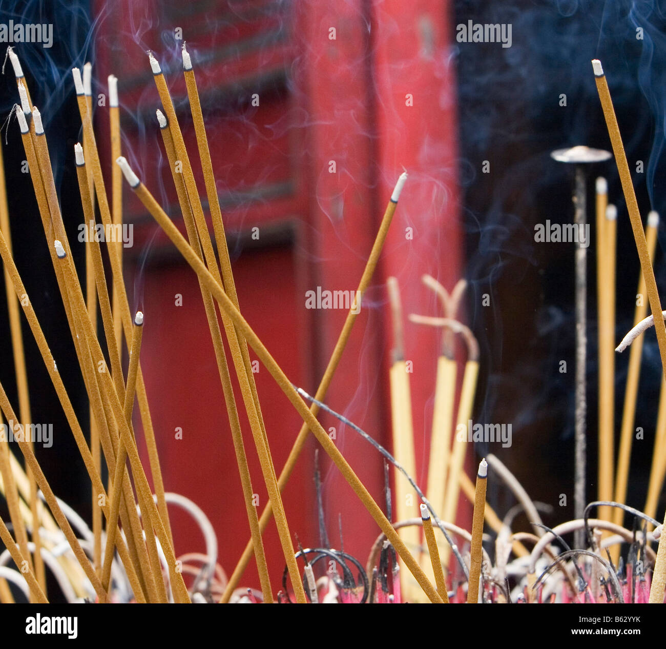 Monk burning an incense stick hi-res stock photography and images - Alamy
