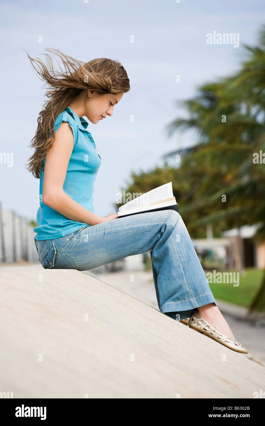 Side profile of a young woman reading a book Stock Photo - Alamy