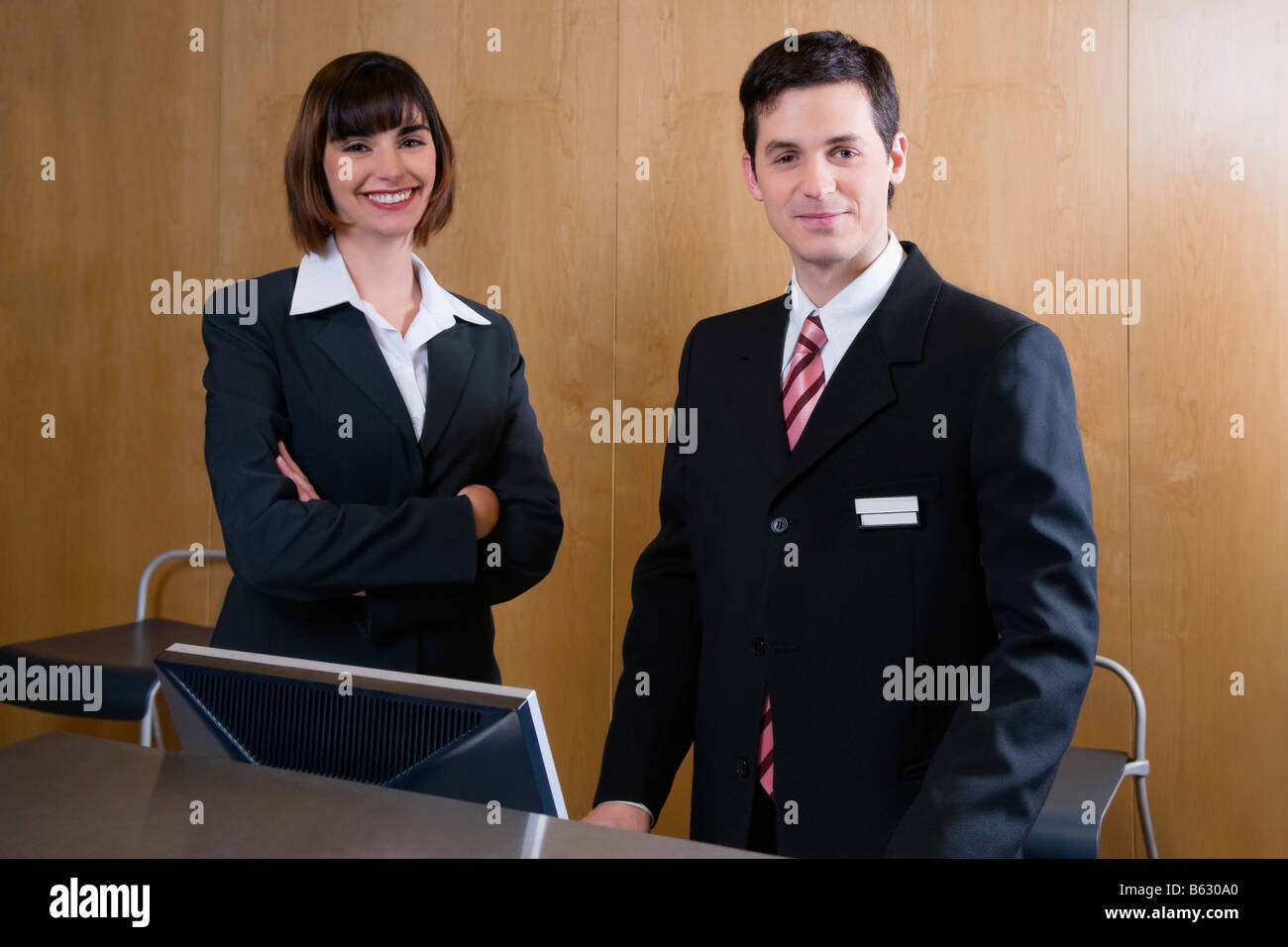 Portrait of two receptionists at the hotel reception Stock Photo - Alamy